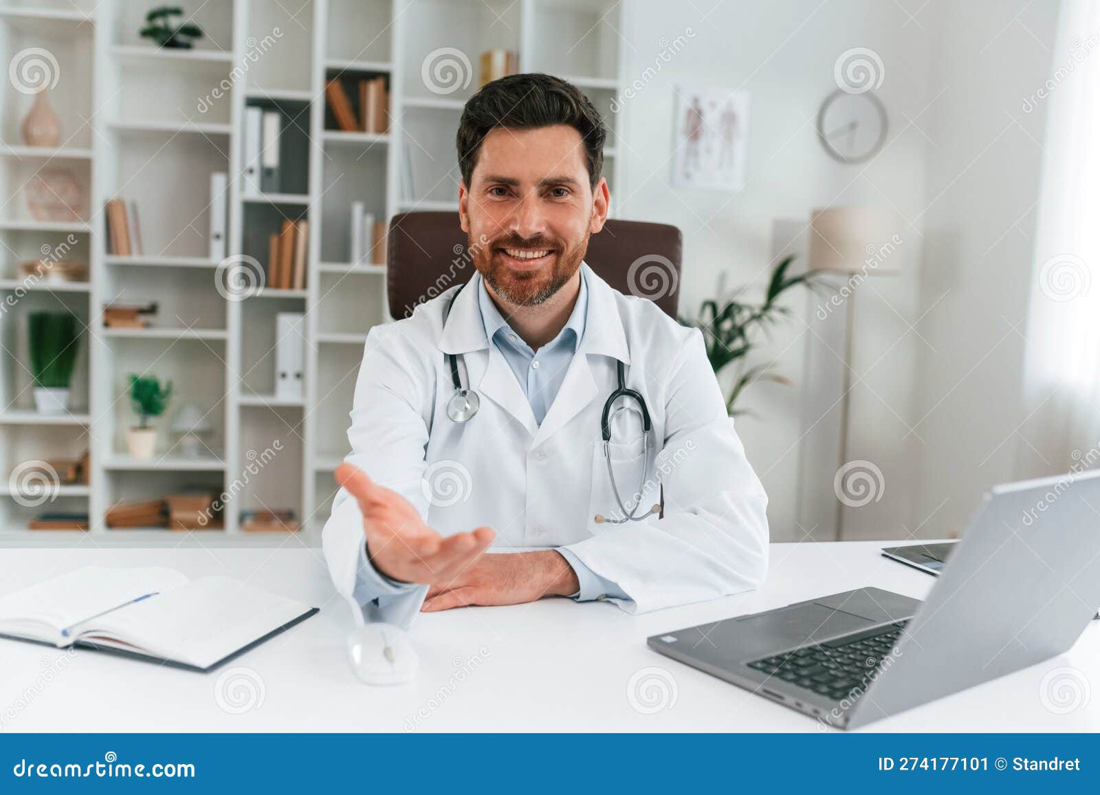 Sitting by a Table. Doctor in Formal Clothes is Working in the Cabinet ...