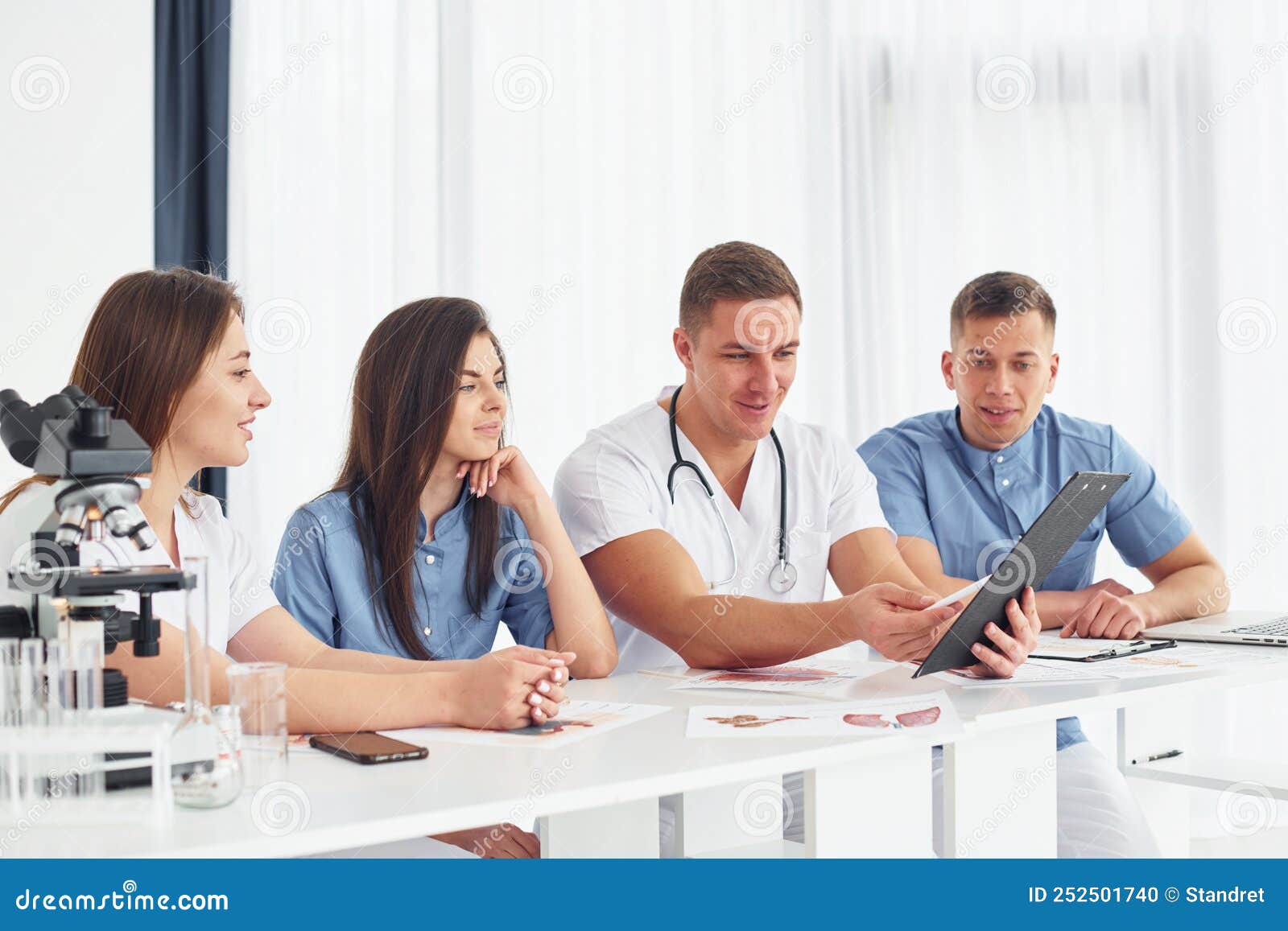 Sitting by the Table. Group of Young Doctors is Working Together in the ...