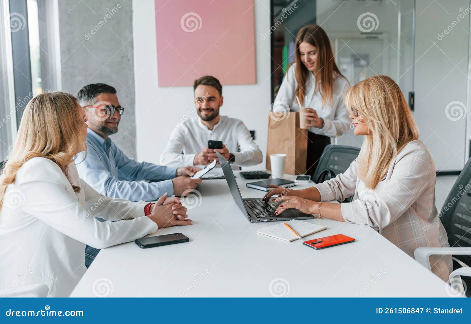 Sitting by the Table Together and Having a Conversation. Group of ...