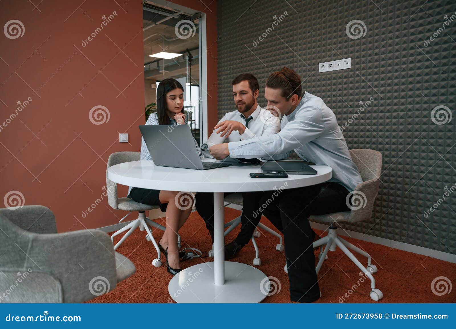 Sitting, Talking, Using Laptop. Office Workers are Indoors by the Table ...
