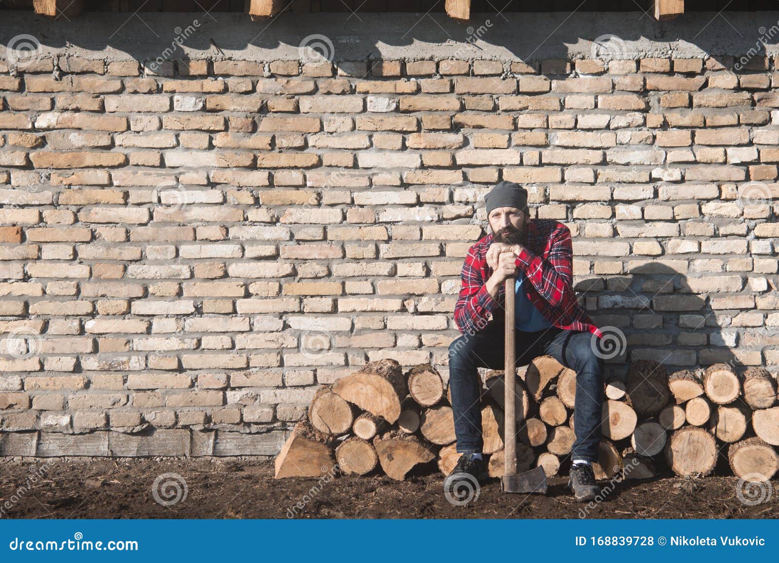 Tired Woodcutter After Hard Work In Forest With Chainsaw. Lumberjack ...
