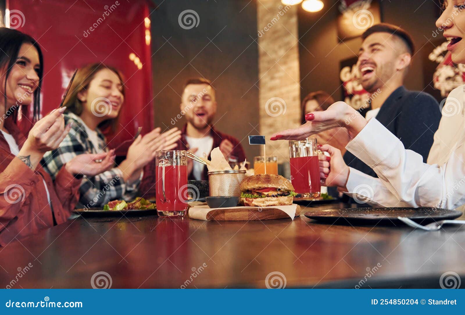 Sitting Together. Group of Young Friends in Bar with Beer Stock Photo ...