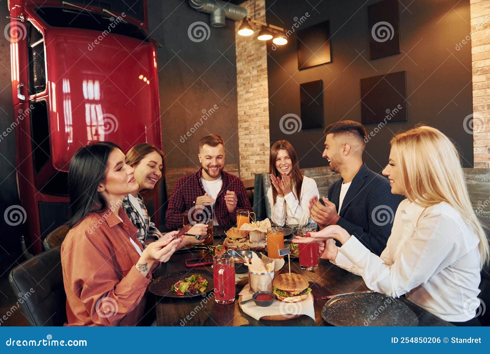 Sitting Together. Group of Young Friends in Bar with Beer Stock Photo ...
