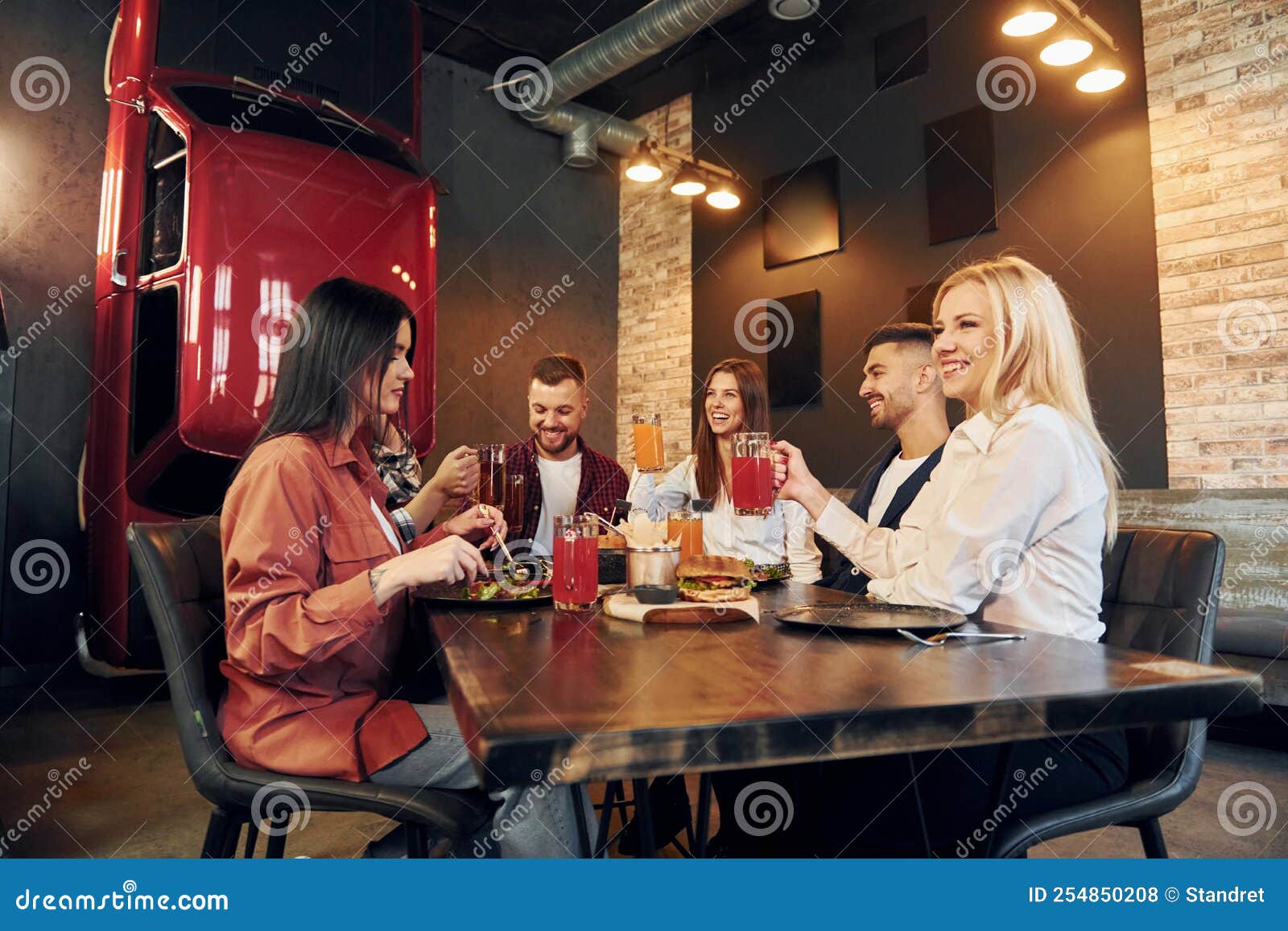 Sitting Together. Group of Young Friends in Bar with Beer Stock Photo ...