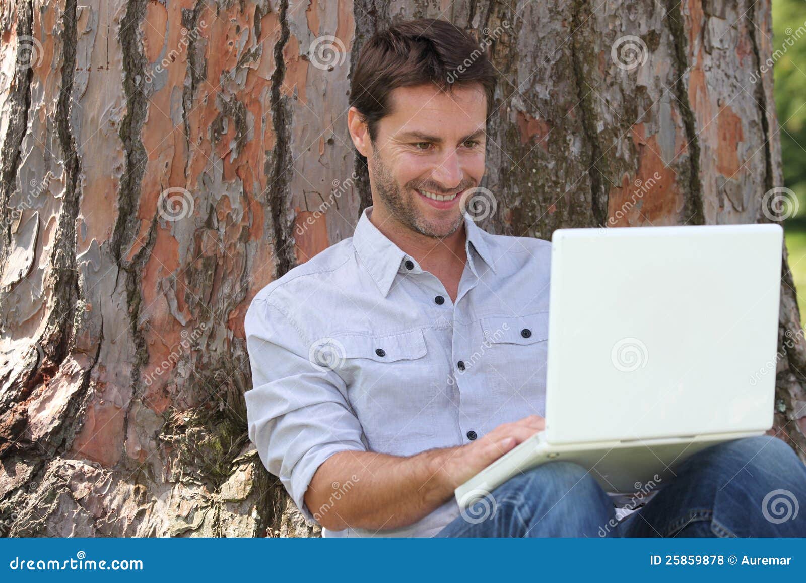 Sitting by Tree with Laptop Stock Photo - Image of happy, smiling: 25859878