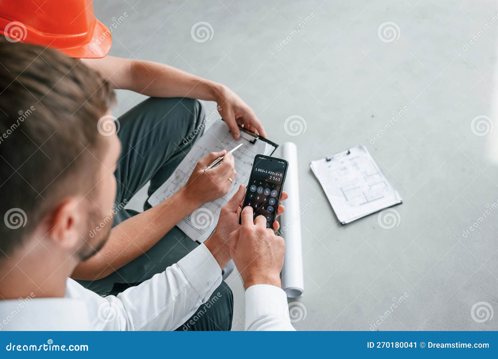Sitting, Using Calculator. Manager with Foreman are Working on the ...