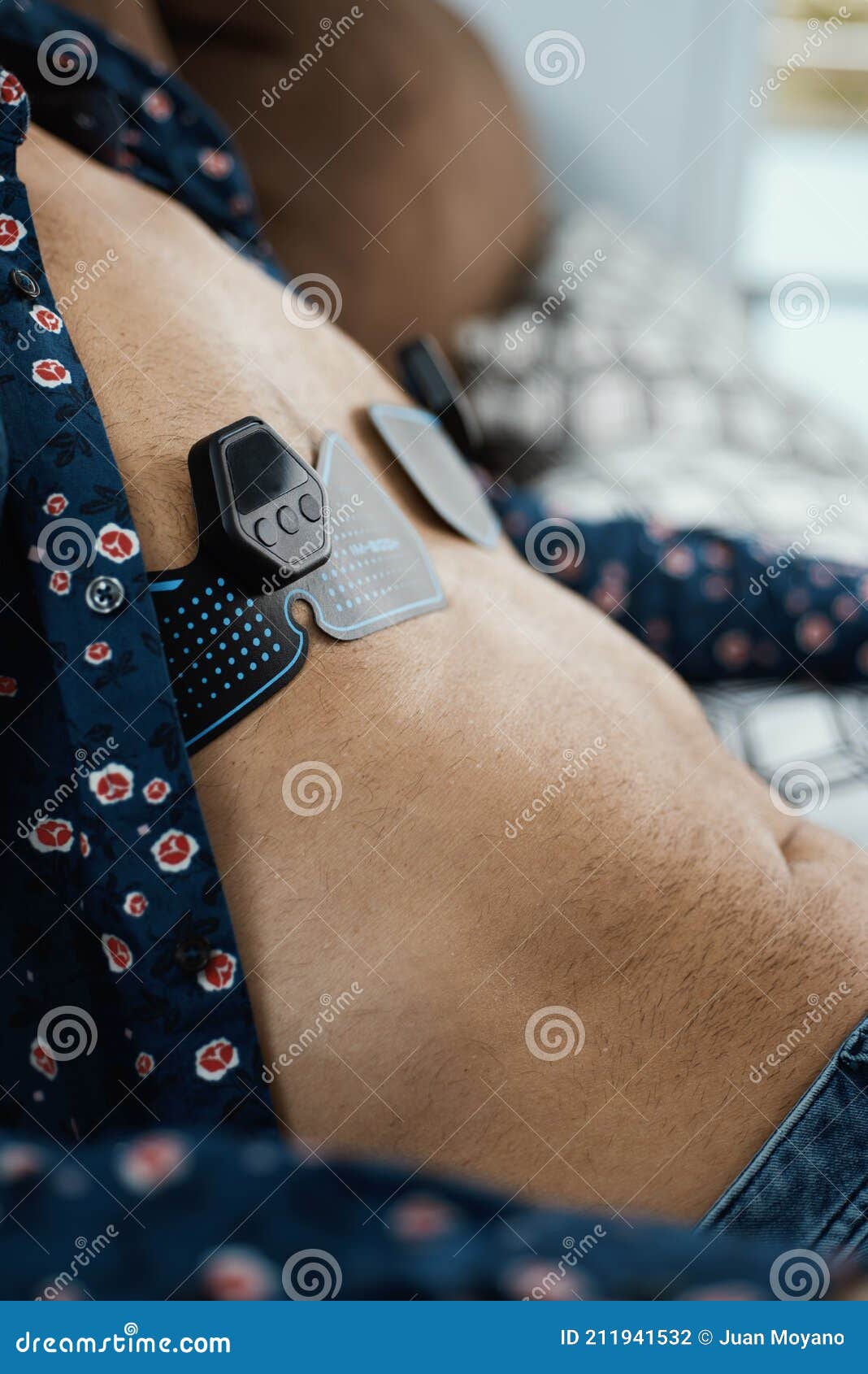 Sitting and Using Muscle Stimulation Device Stock Photo - Image of ...