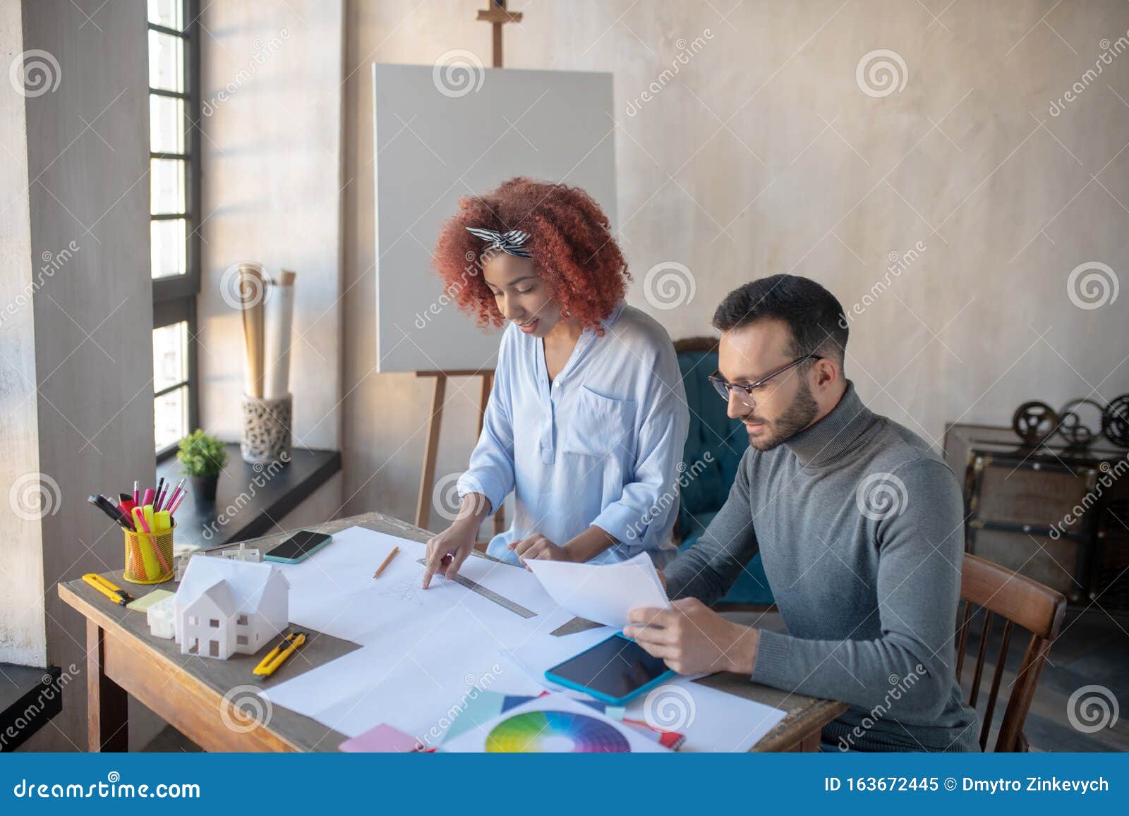 Two Interior Designers Sitting at the Table and Working Stock Image ...