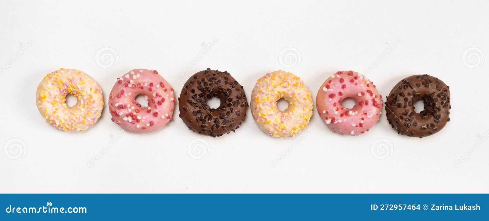 Six Donuts in a Row - White, Pink and Chocolate on a White Background ...