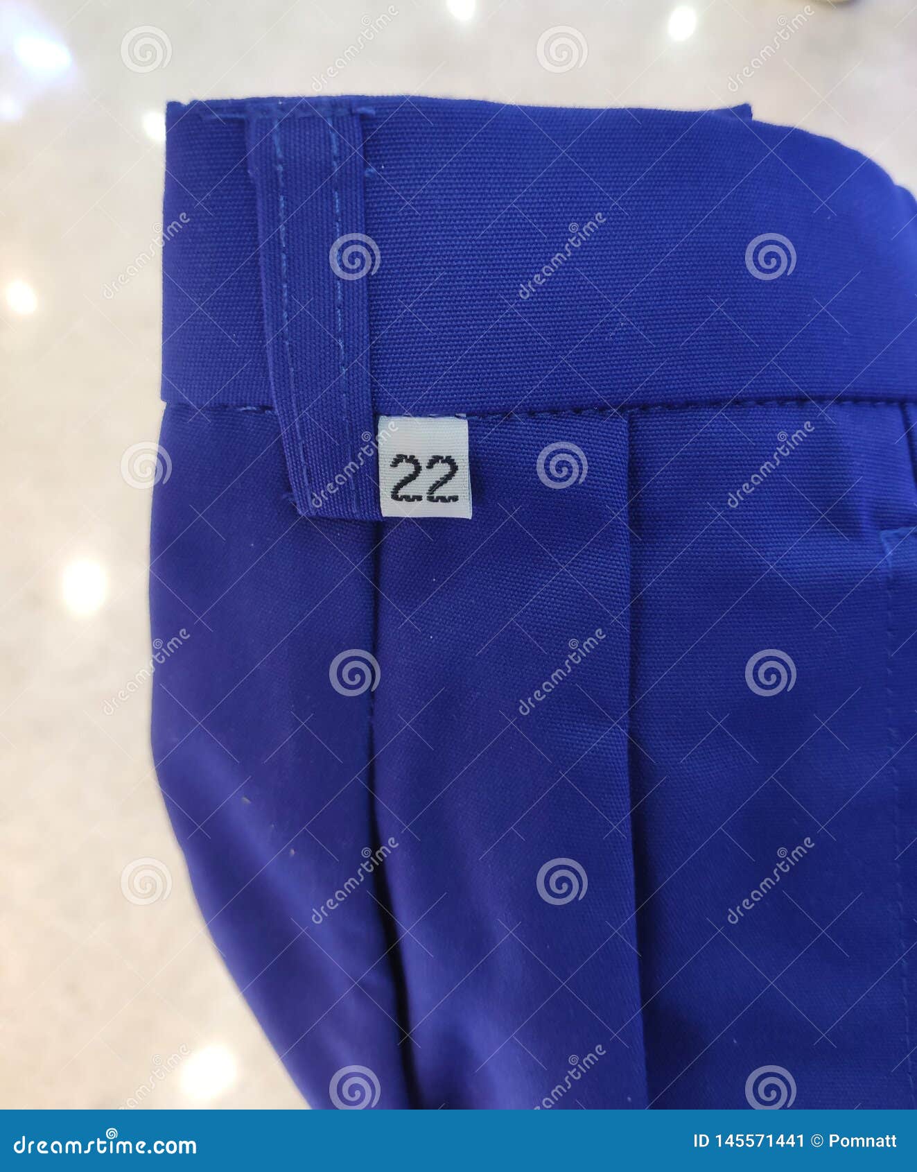 Size label on blue shorts stock image. Image of label - 145571441