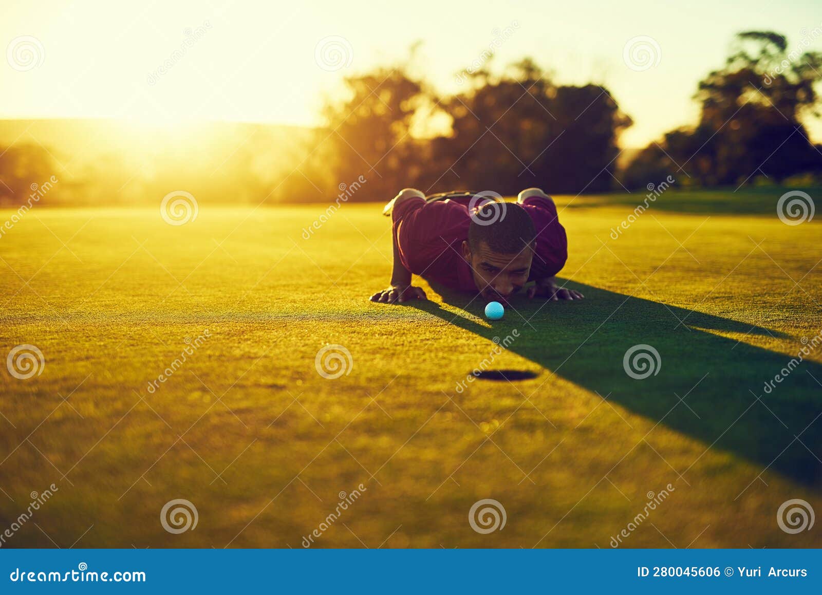 Sizing it Up before he Sinks it. a Young Man Eyeing Up the Putt during ...