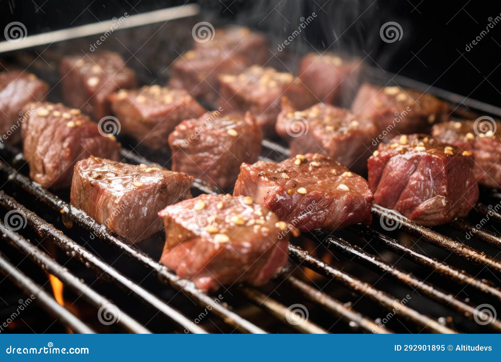 Sizzling Steak Tips with Garlic Glaze Bubbles on Grill Surface Stock ...