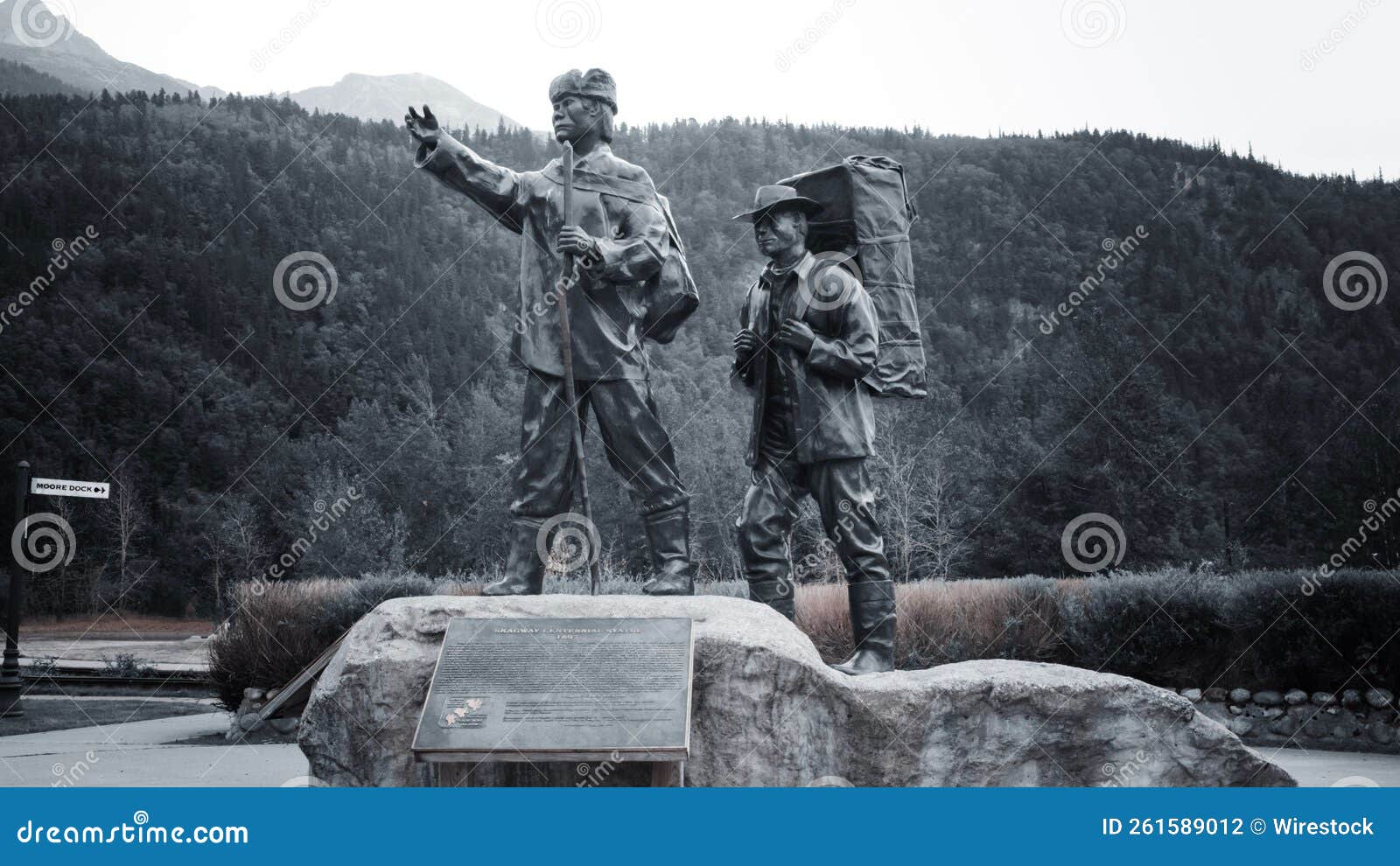 Skagway Centennial Statue with Dense Forest Background in Gloomy Colors ...