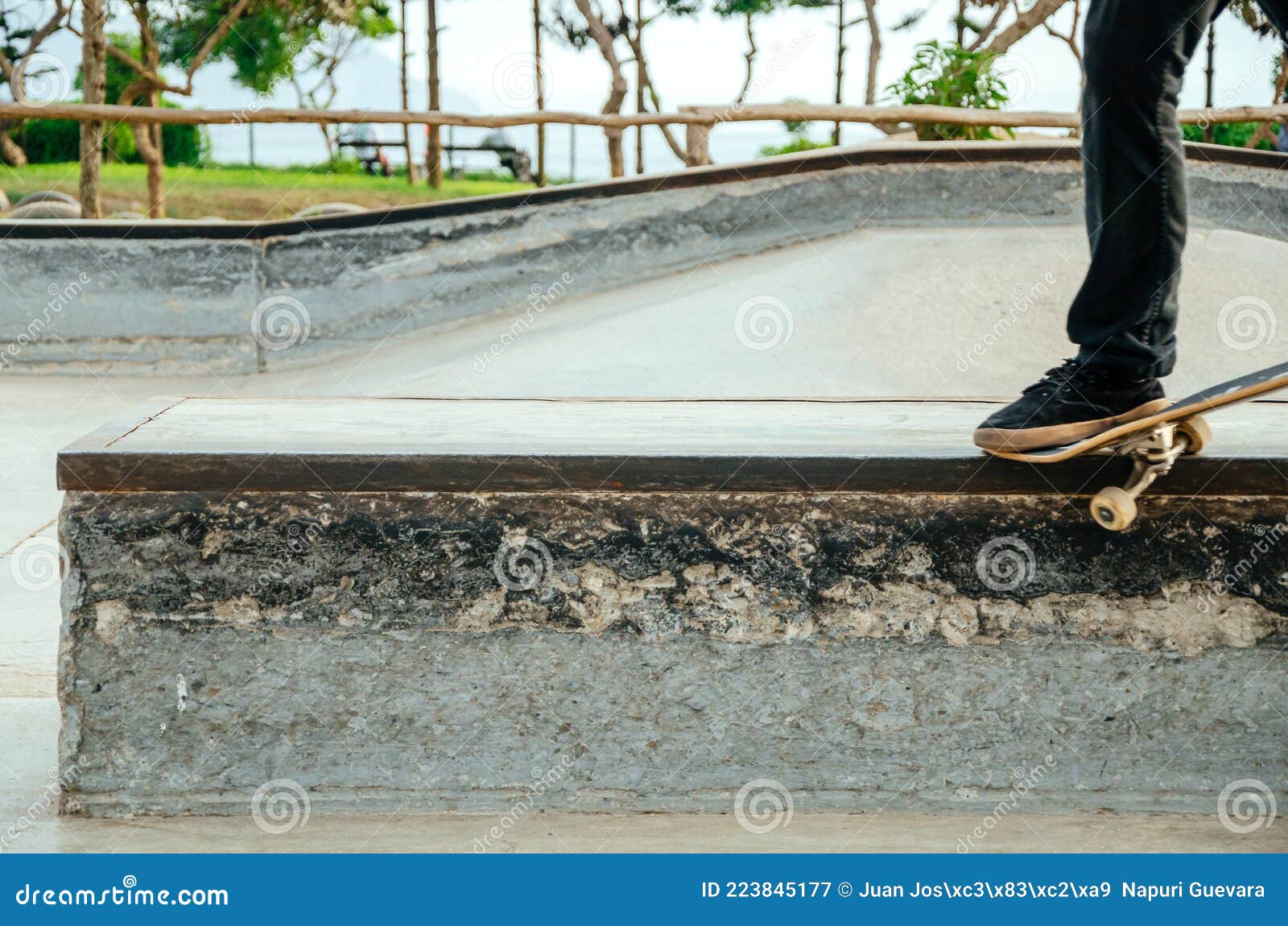 Skateboarder is Doing a Crooked Grind Trick on a Bench in Skatepark ...