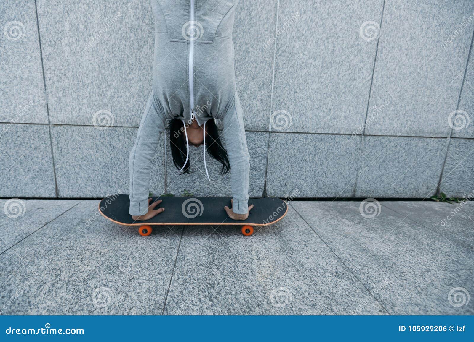 Skateboarder Doing a Handstand on Skateboard Against Wall Stock Photo ...