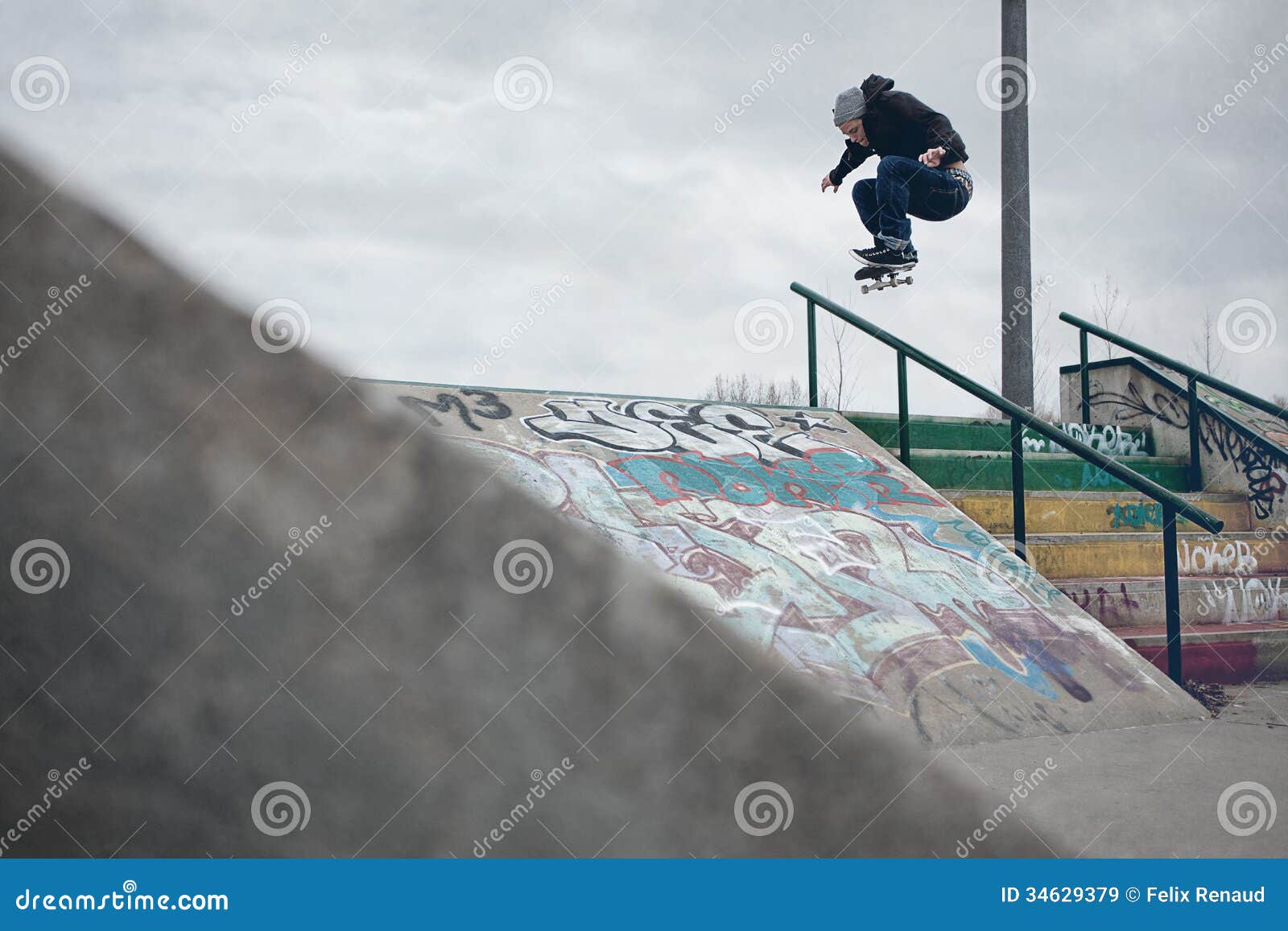 Skateboarder Doing a Ollie Over the Rail in a Skatepark Stock Image ...