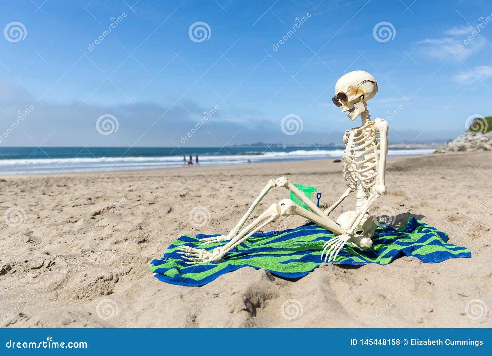 Skeleton on a Beach Towel Relaxing in the Sand on the Coast Stock Photo ...