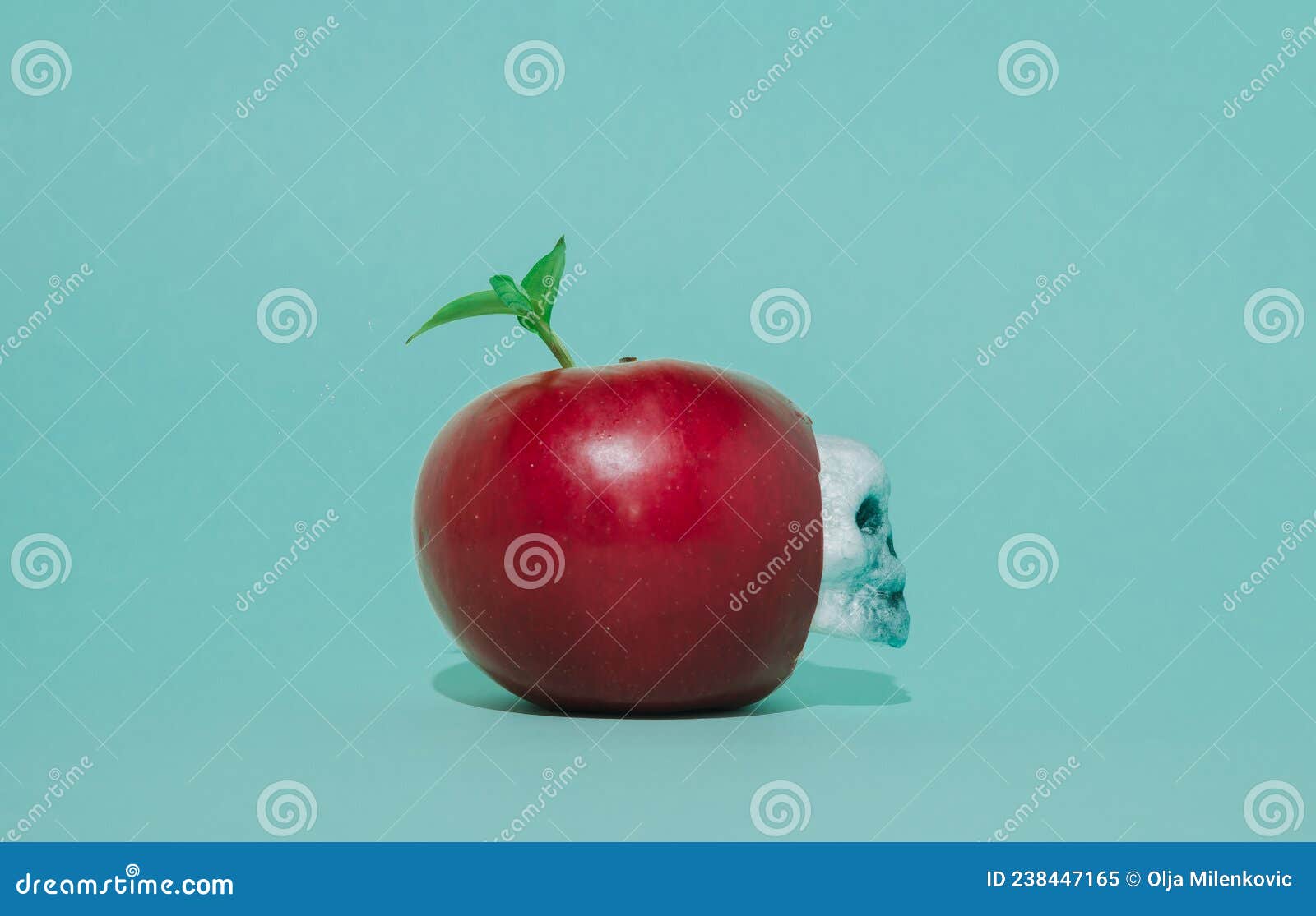 Skeleton Head Coming Out of a Red Apple. Blue Background Stock Image ...