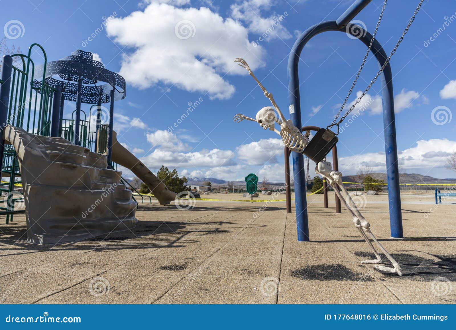 Skeleton Playing Superman on a Child S Swing in an Empty Park Stock ...