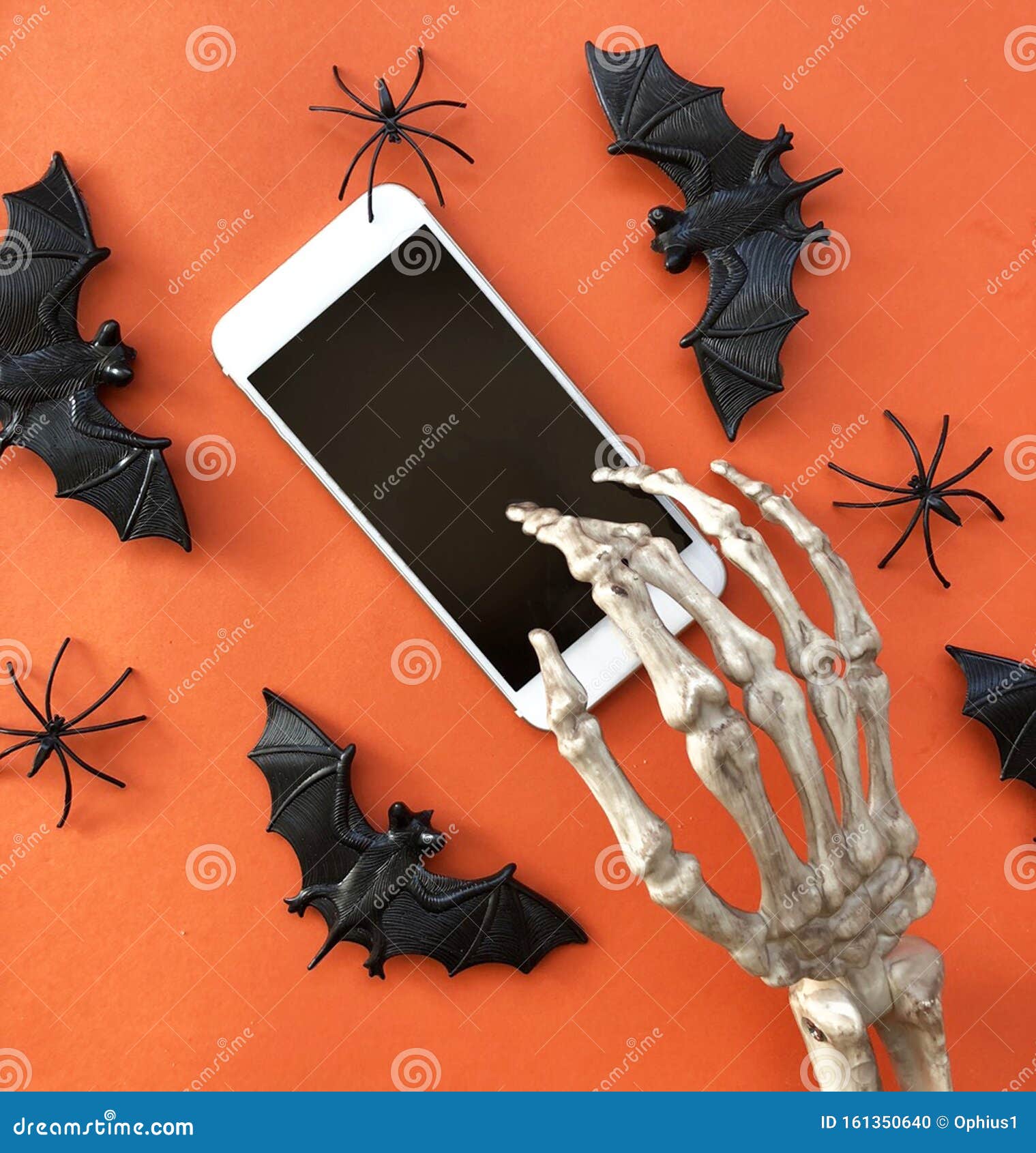 Skeleton Using Smartphone. Bats and Spiders on Orange Background Stock ...