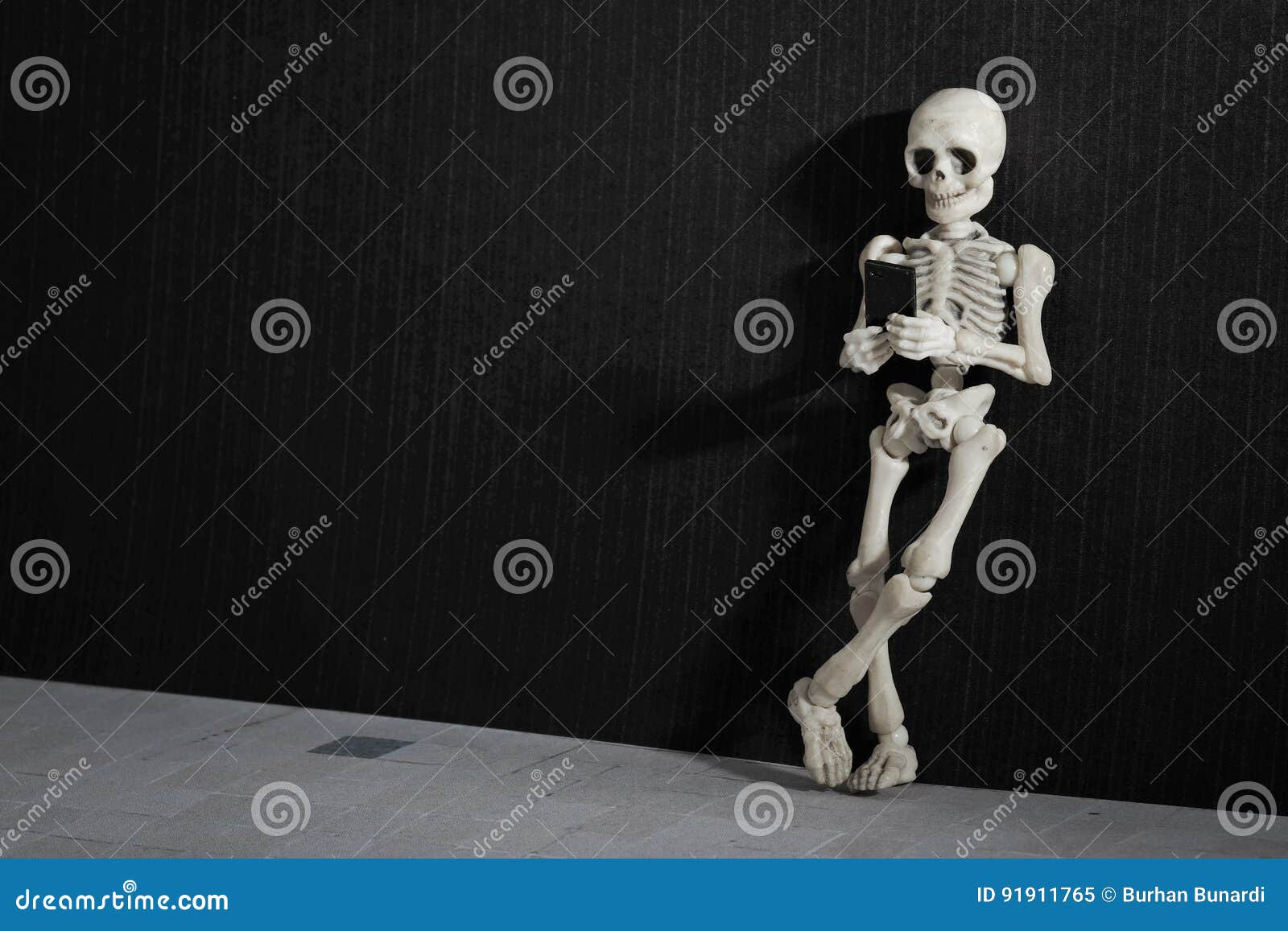Skeleton and smartphone stock image. Image of brick, halloween - 91911765