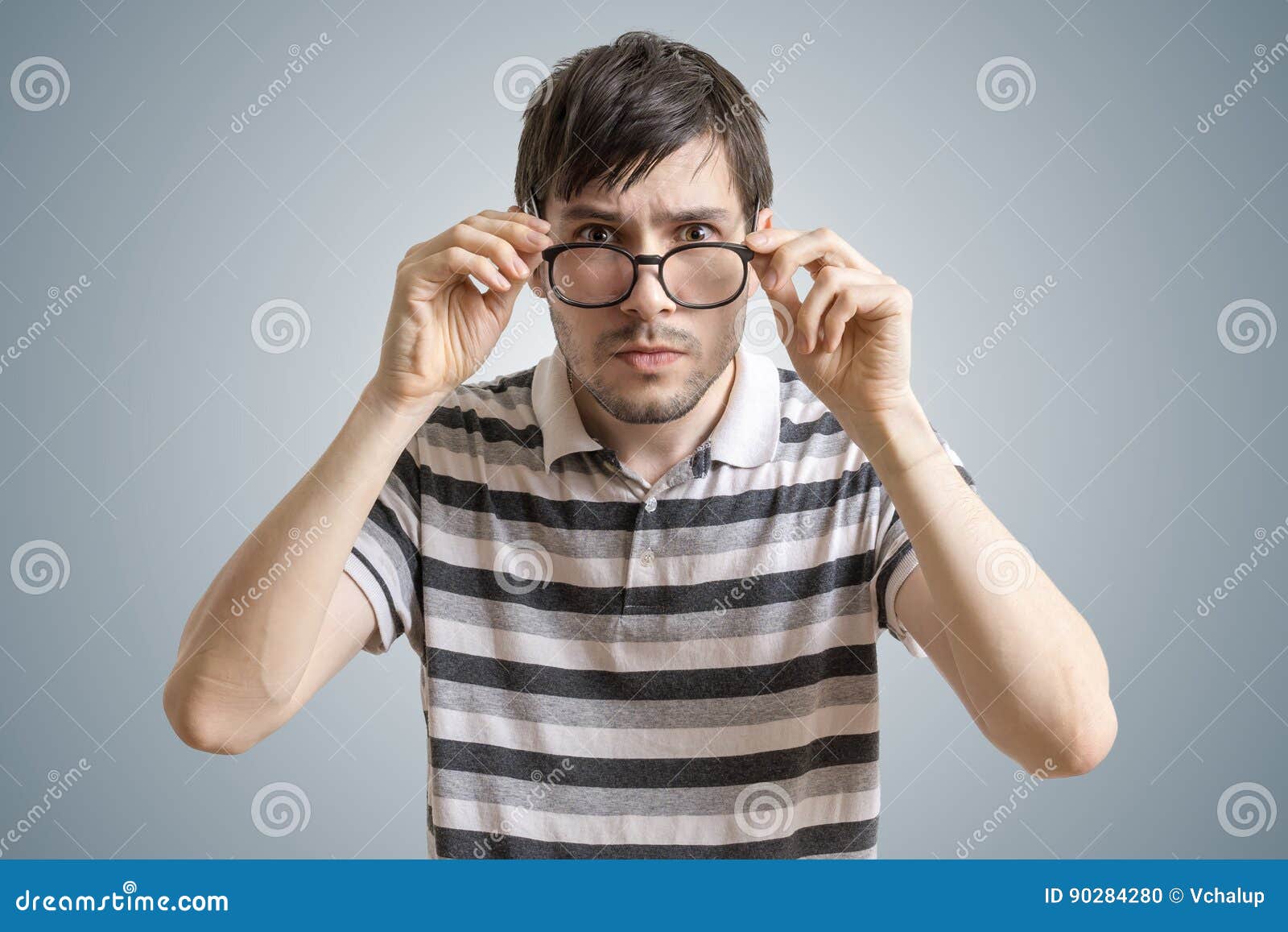 Skeptical or Suspicious Man is Looking at You and Touching Glasses ... Skeptical or Suspicious Man is Looking at You and Touching Glasses ...