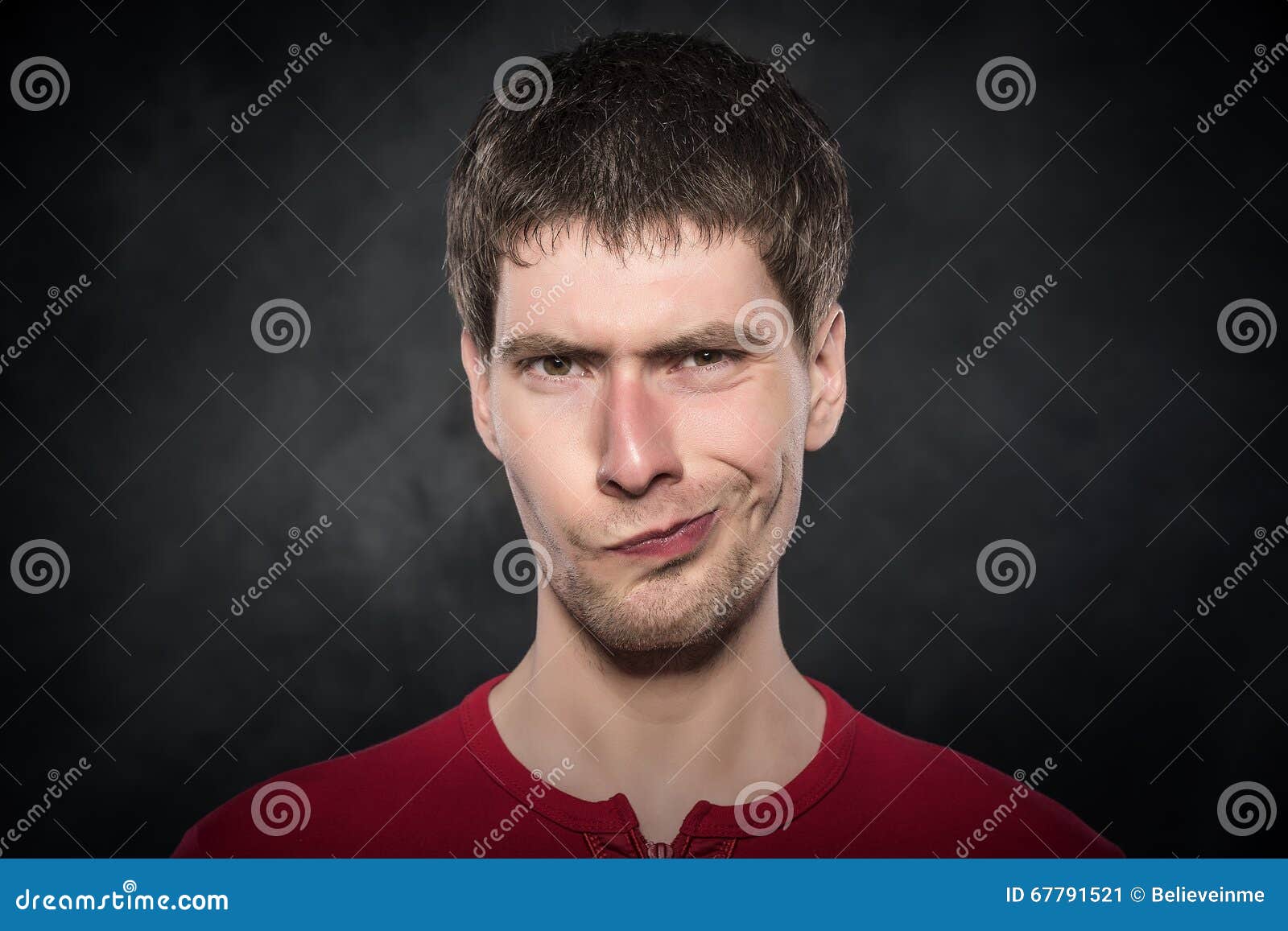 Skeptical young man. stock image. Image of background - 67791521