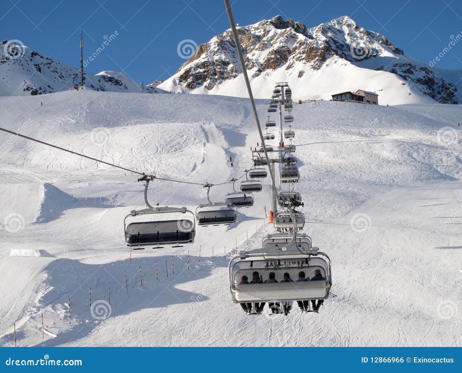 Ski chair-lift with skiers stock photo. Image of snowboard - 12866966