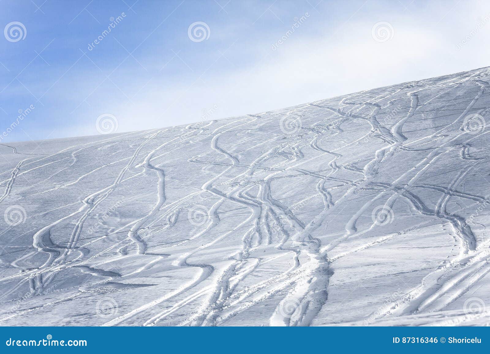 Ski and Snowboard Tracks on a Slope Stock Photo - Image of snow, blue ...