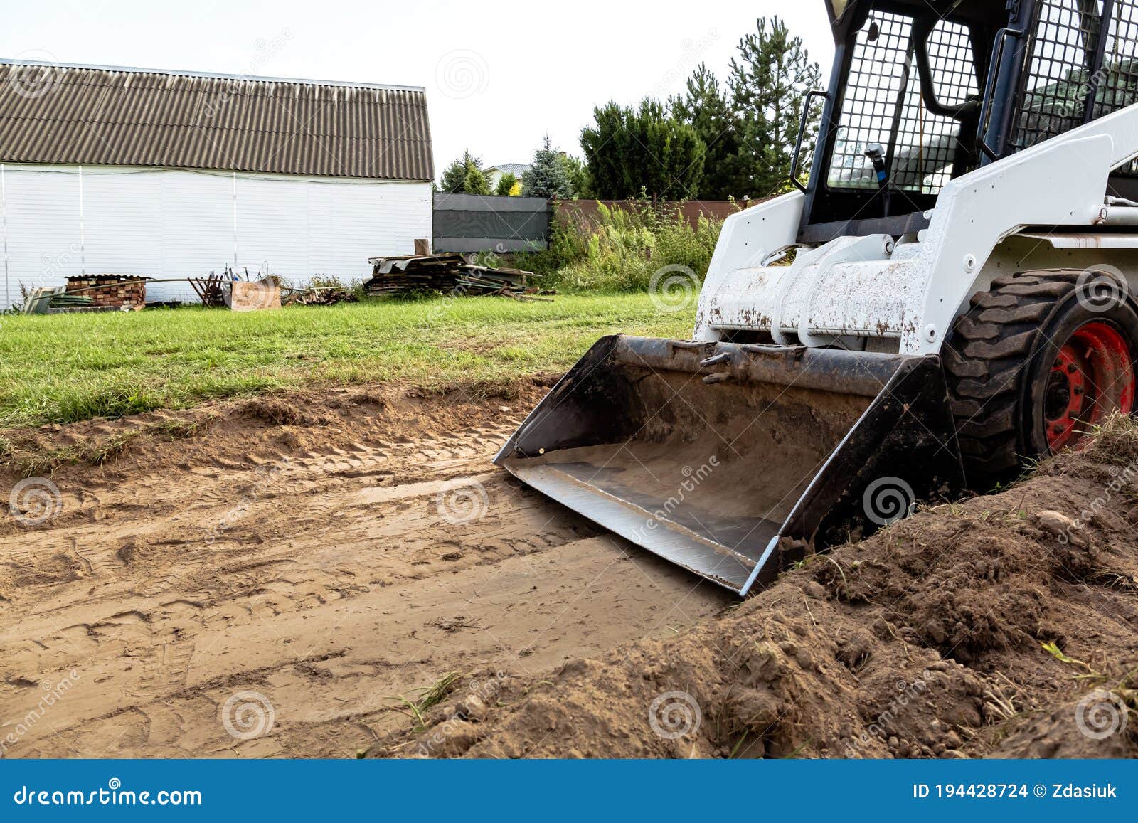 A Skid Steer Loader Clears the Site for Construction. Land Work by the ...