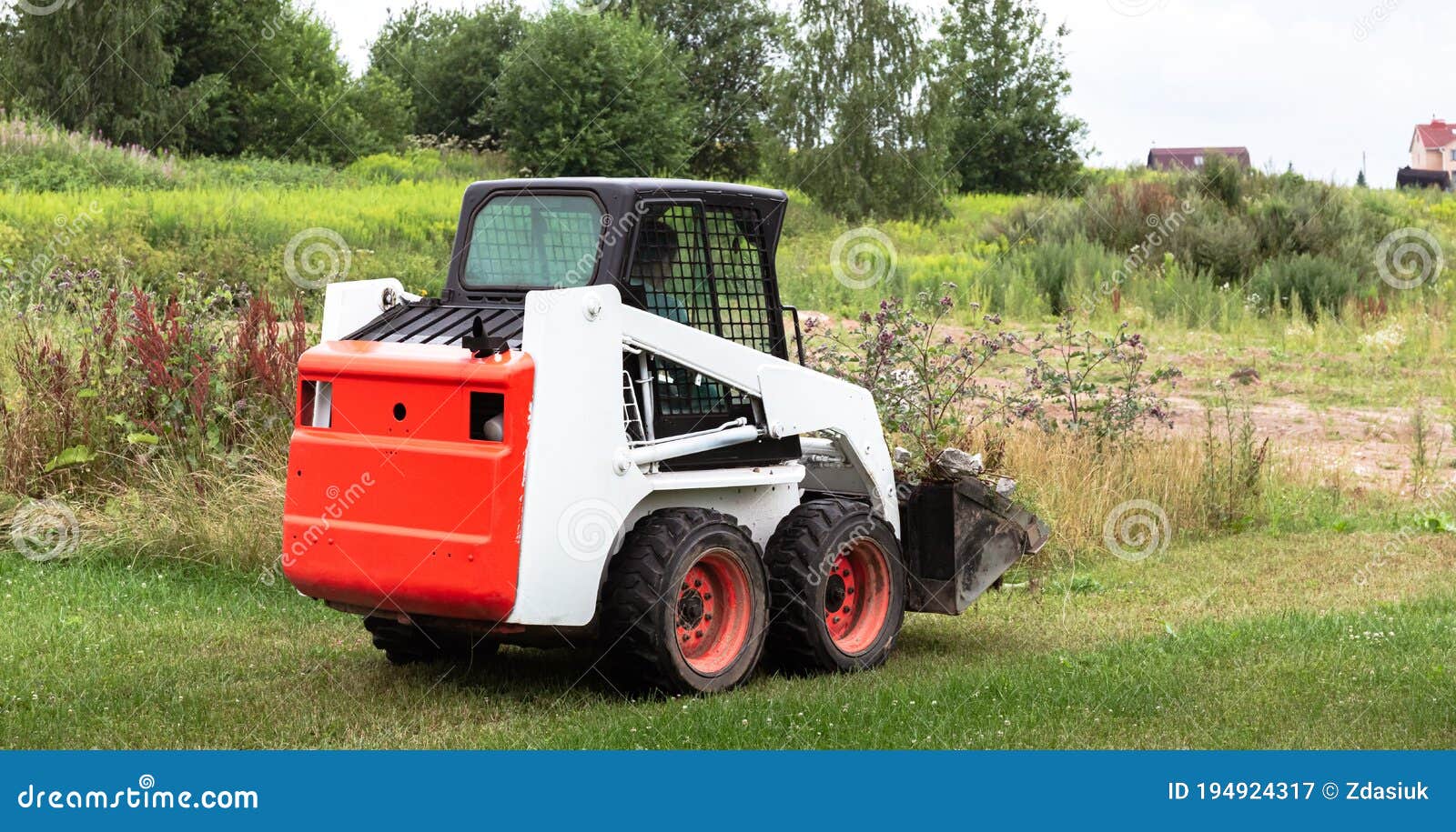 A Skid Steer Loader Clears the Site for Construction. Land Work by the ...