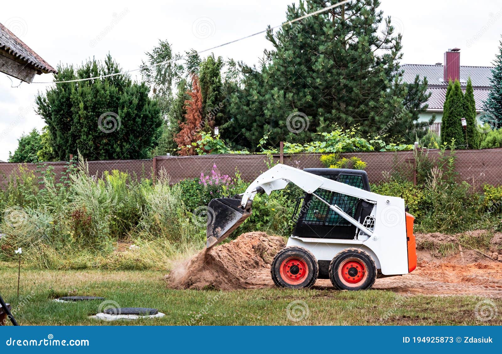 A Skid Steer Loader Clears the Site for Construction. Land Work by the ...