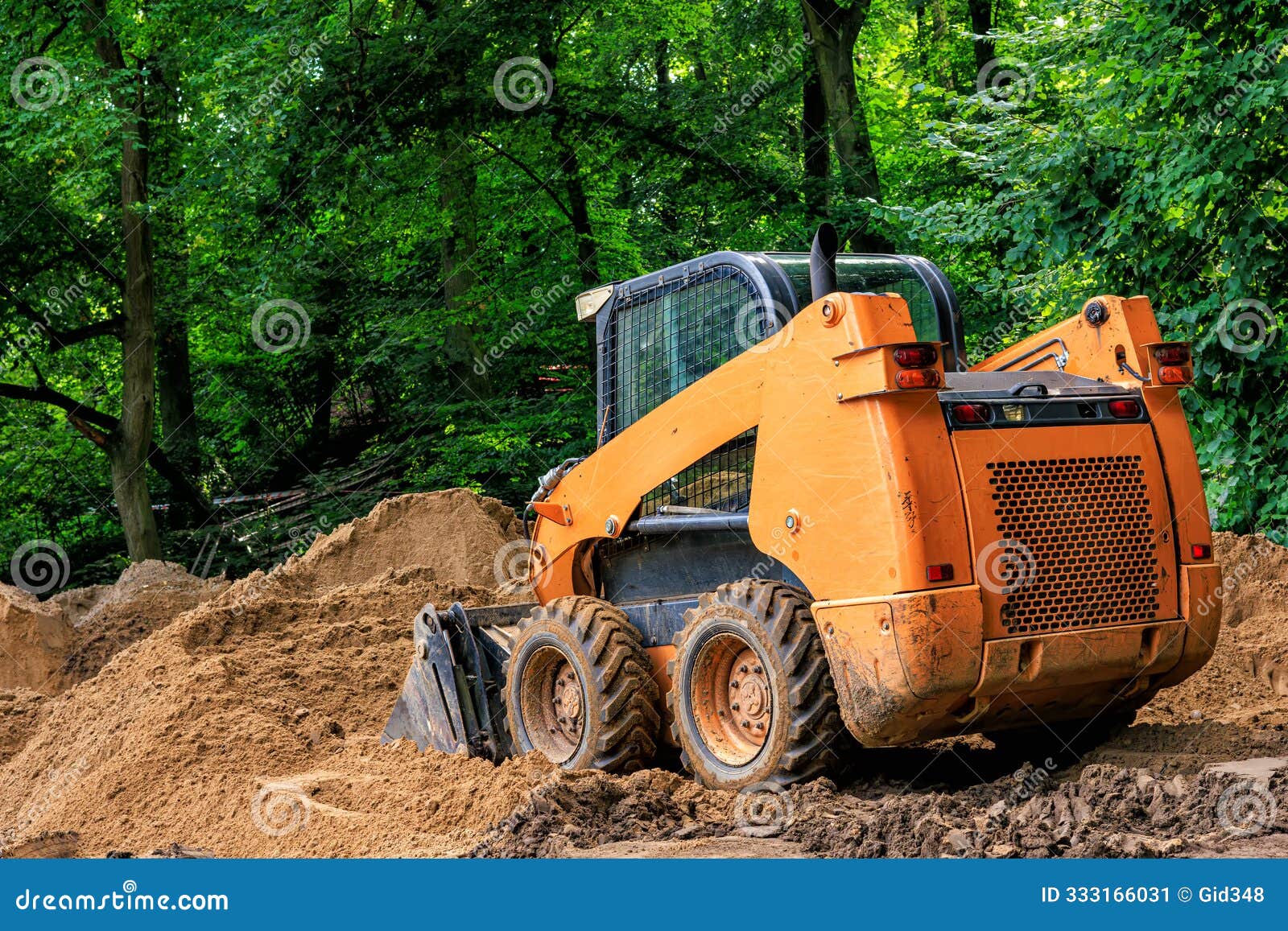 A Skid Steer Loader Shovels Soil in a Park Stock Image - Image of ...