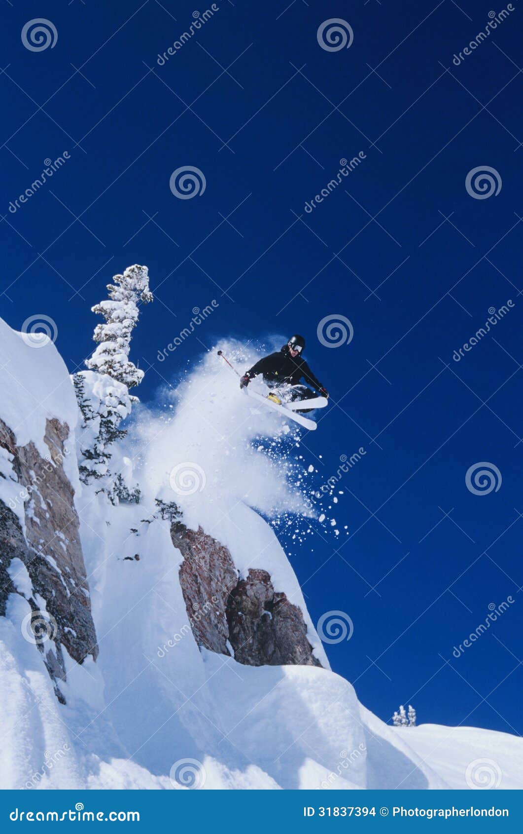 Skier Jumping from Mountain Ledge Stock Photo - Image of people ...