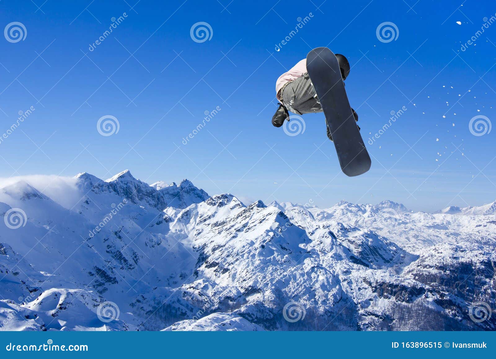 Skier Snowboarder Jumping through Air with Sky in Background Stock ...