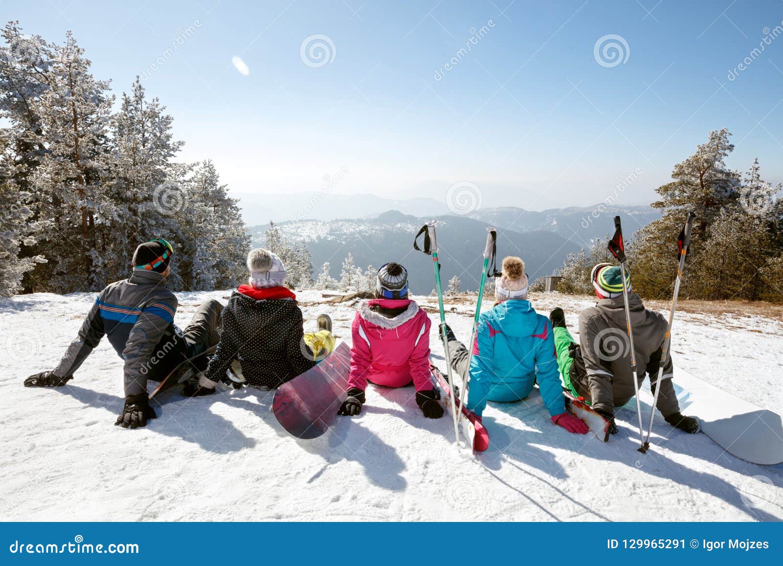 Skiers Resting on Snow from Skiing, Back View Stock Image - Image of ...