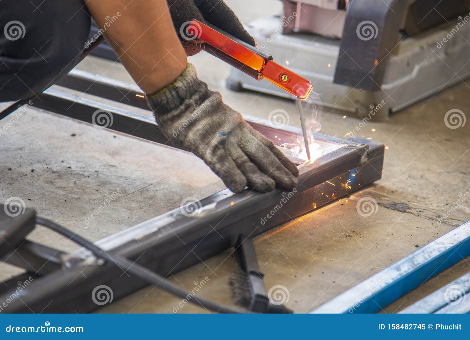 The Skill Worker Use the Electric Welding Machine Welding the Metal ...