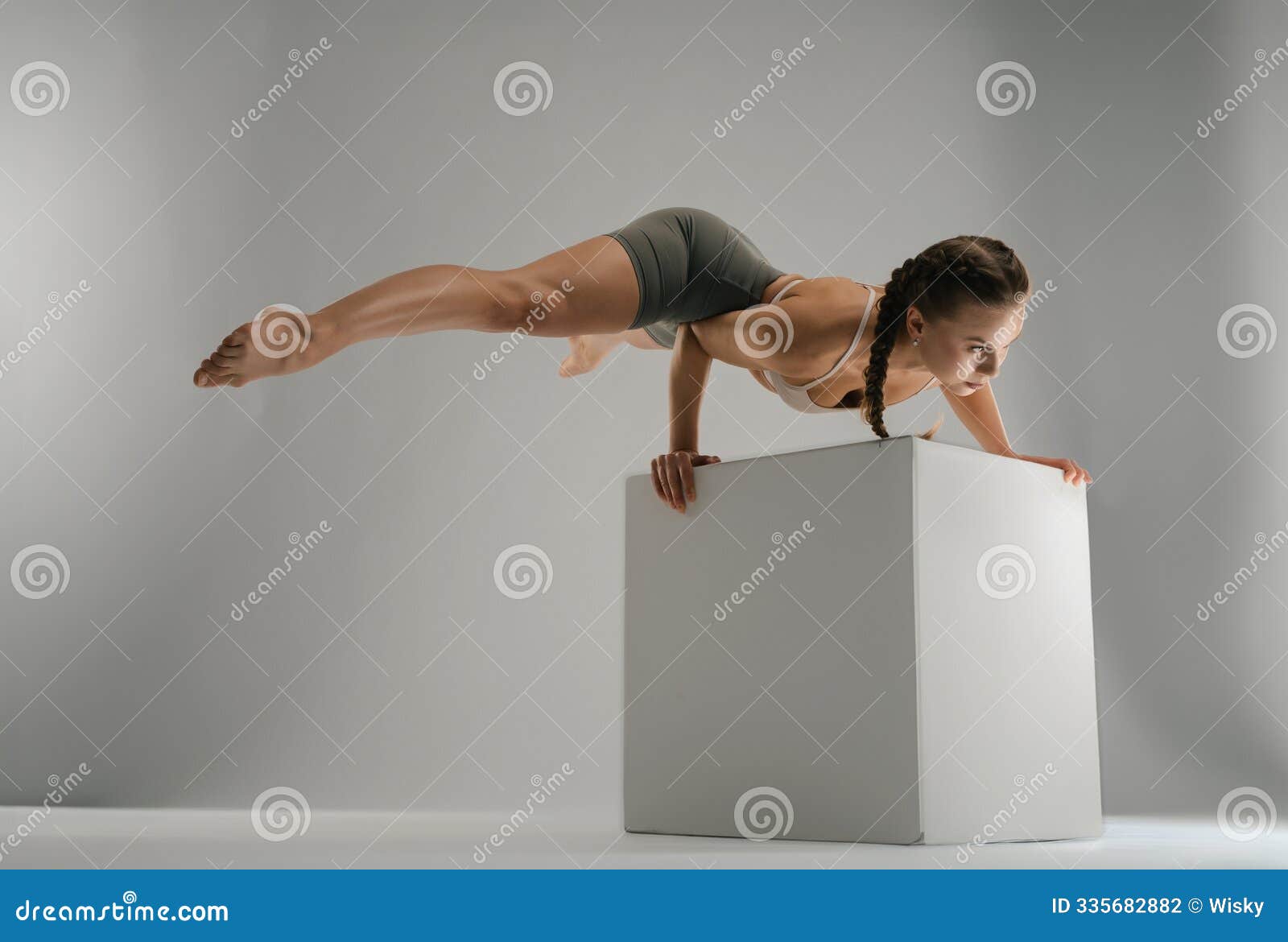 Athlete Performs Impressive Balance Exercise on Cube in a Studio ...