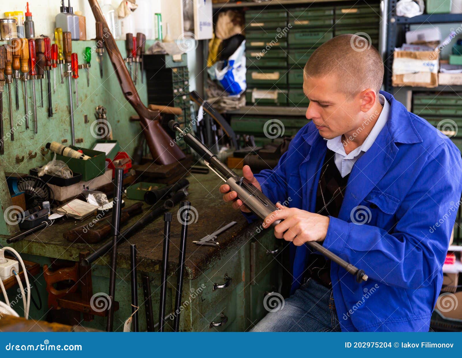 Gunsmith Assembling Shotgun after Diagnostics and Repair in Weapons ...