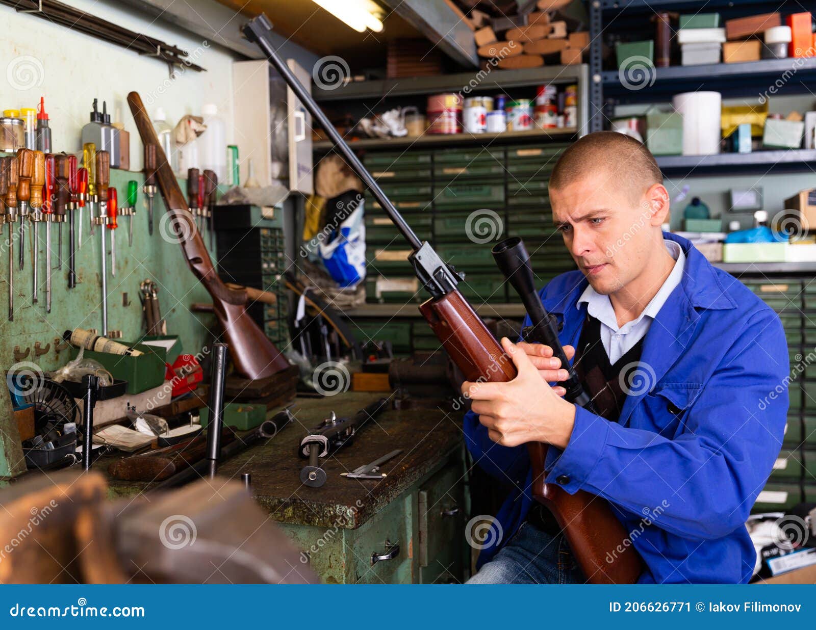 Gunsmith Installing Optical Sight On Rifle In Weapons Workshop Royalty ...