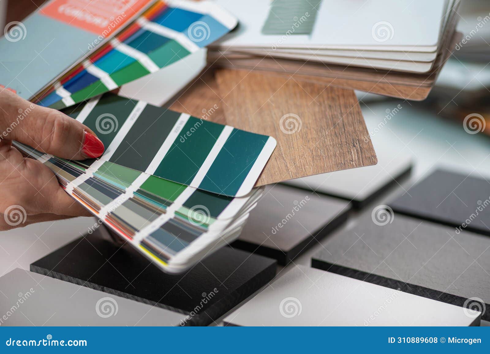 A Skilled Interior Designer Carefully Matches Color Samples, Selecting ...