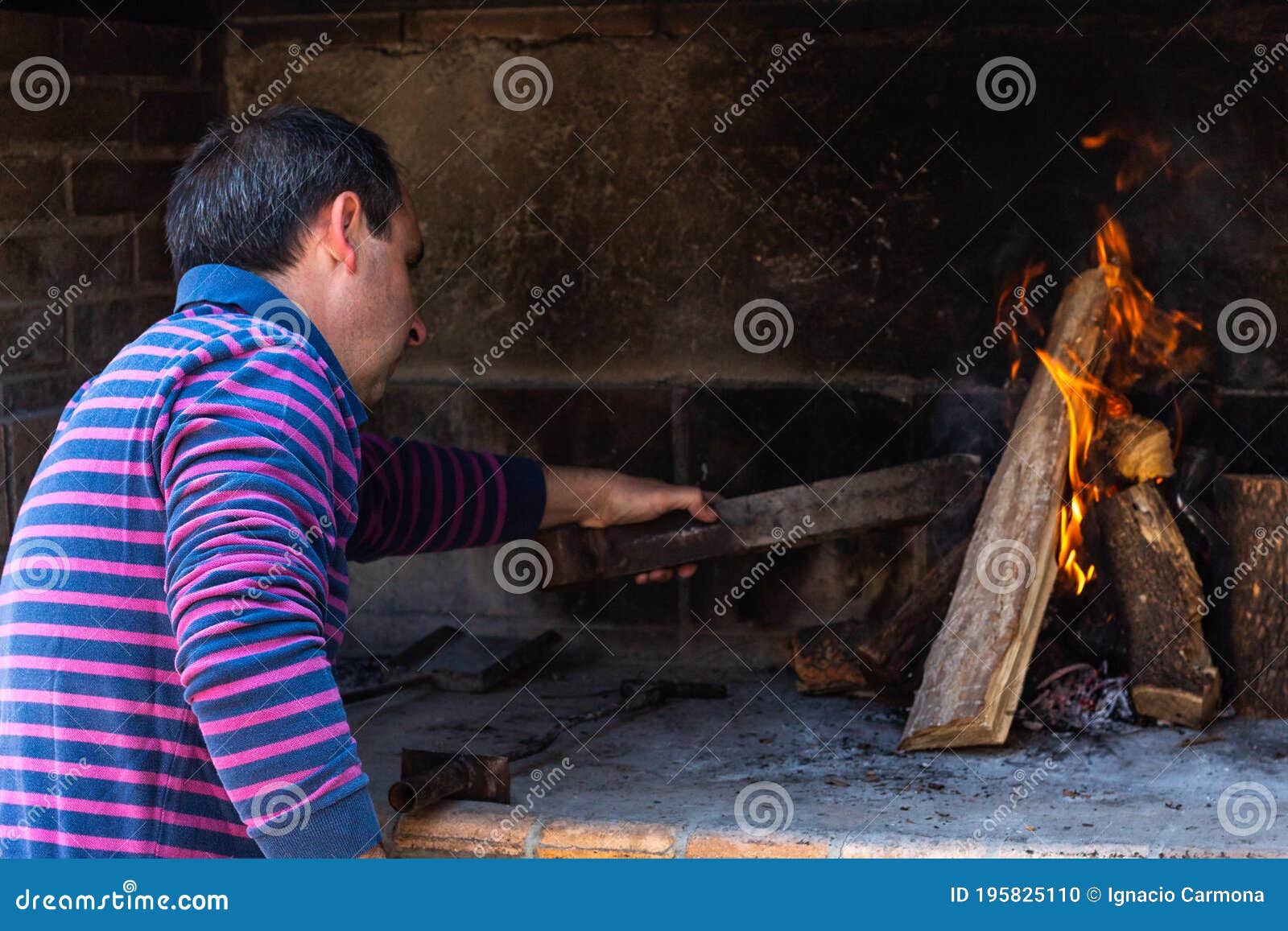 Skilled Man Setting the Fire To Cook a Roasted Meat. Stock Photo ...