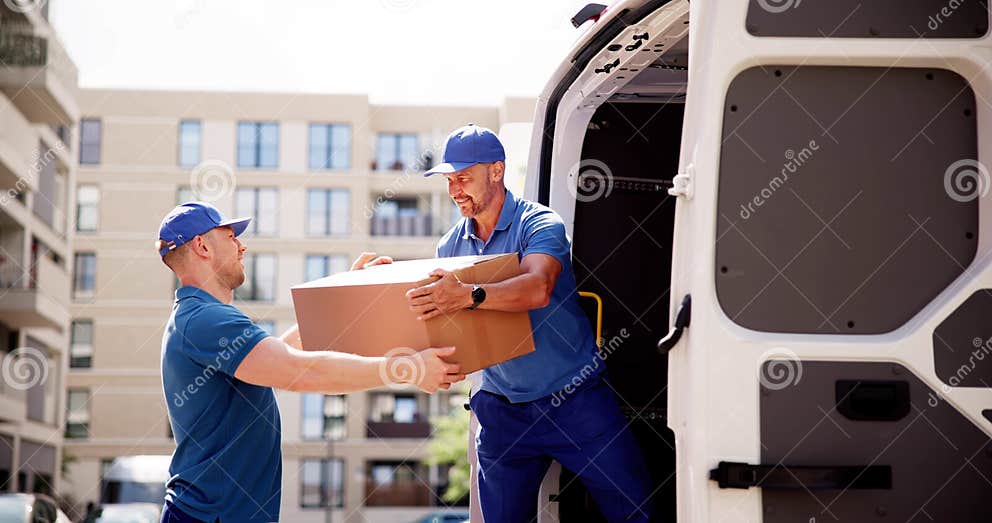 Skilled Movers in Action: Experienced Caucasian Men Loading Boxes into ...