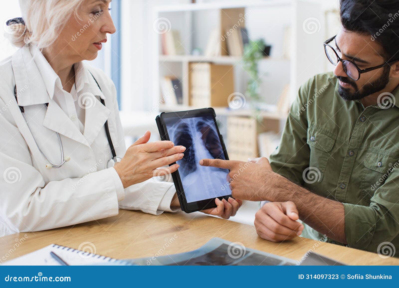 Skilled Radiologist in White Uniform Explaining Visible Changes on X ...