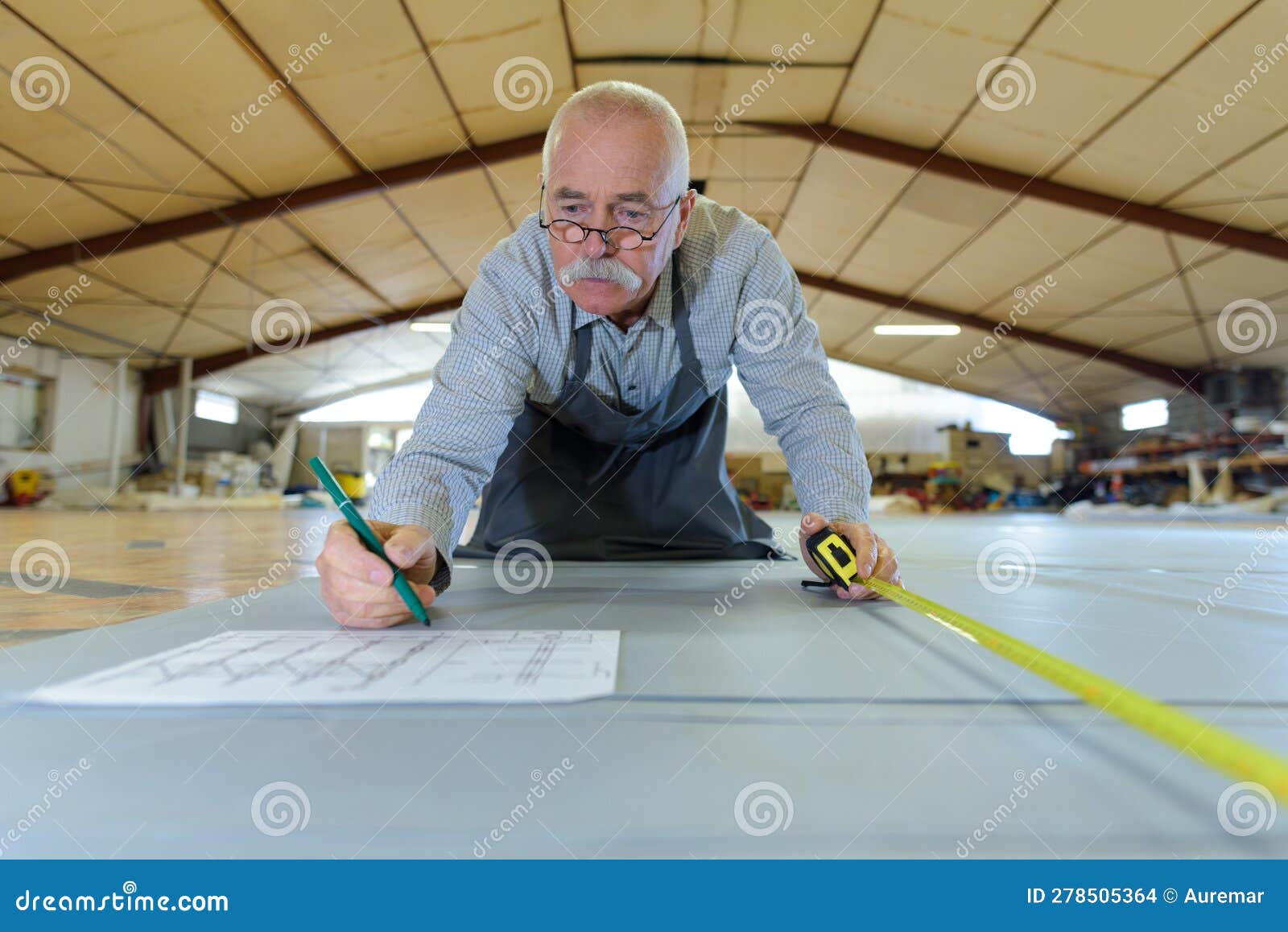 Skilled Senior Carpenter Doing Precise Blueprint Measurements Stock ...