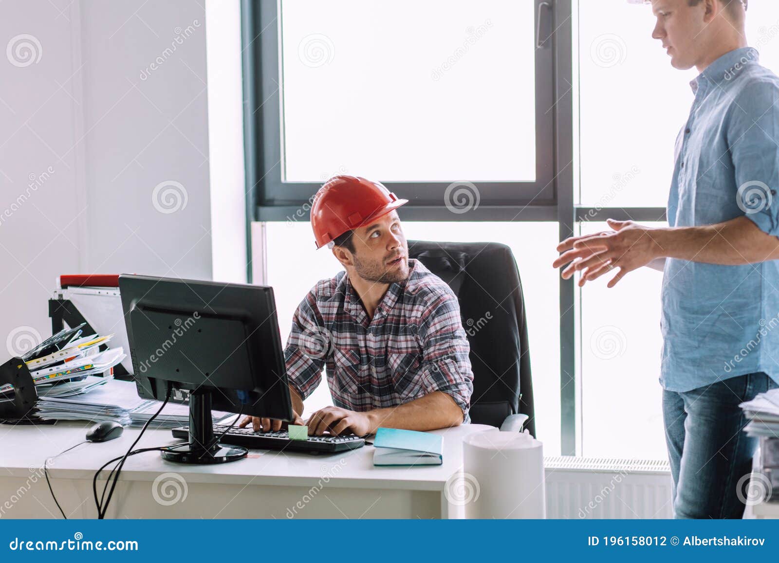 Skilled Technician is Talking with Colleague at Work Stock Photo ...