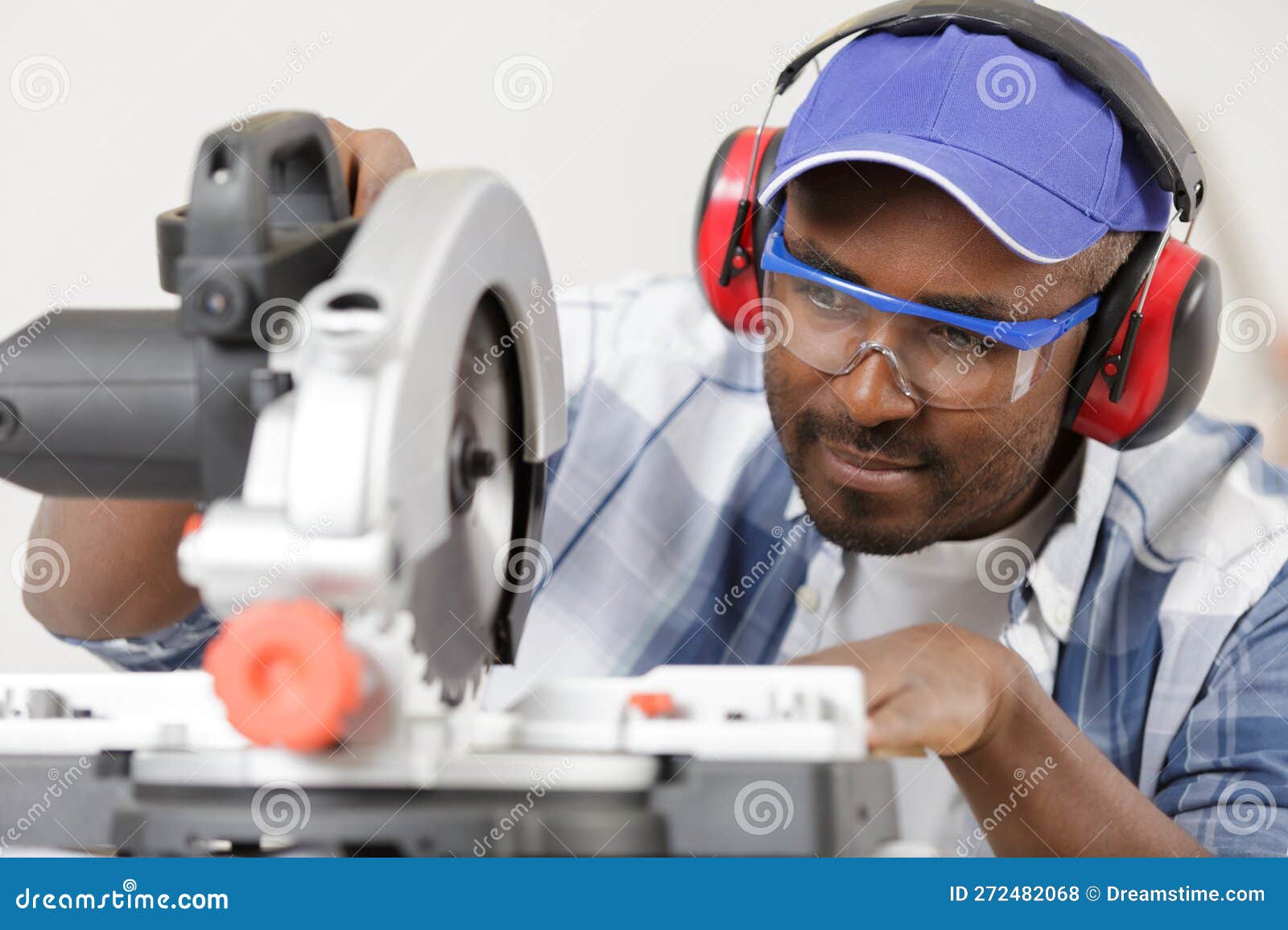 Skilled Woodworker Wearing Safety Gear Using Mitre Saw Stock Photo ...
