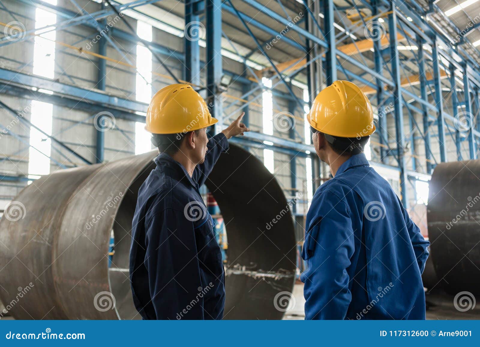 Skilled Worker Pointing Up while Giving Instructions To an Apprentice ...