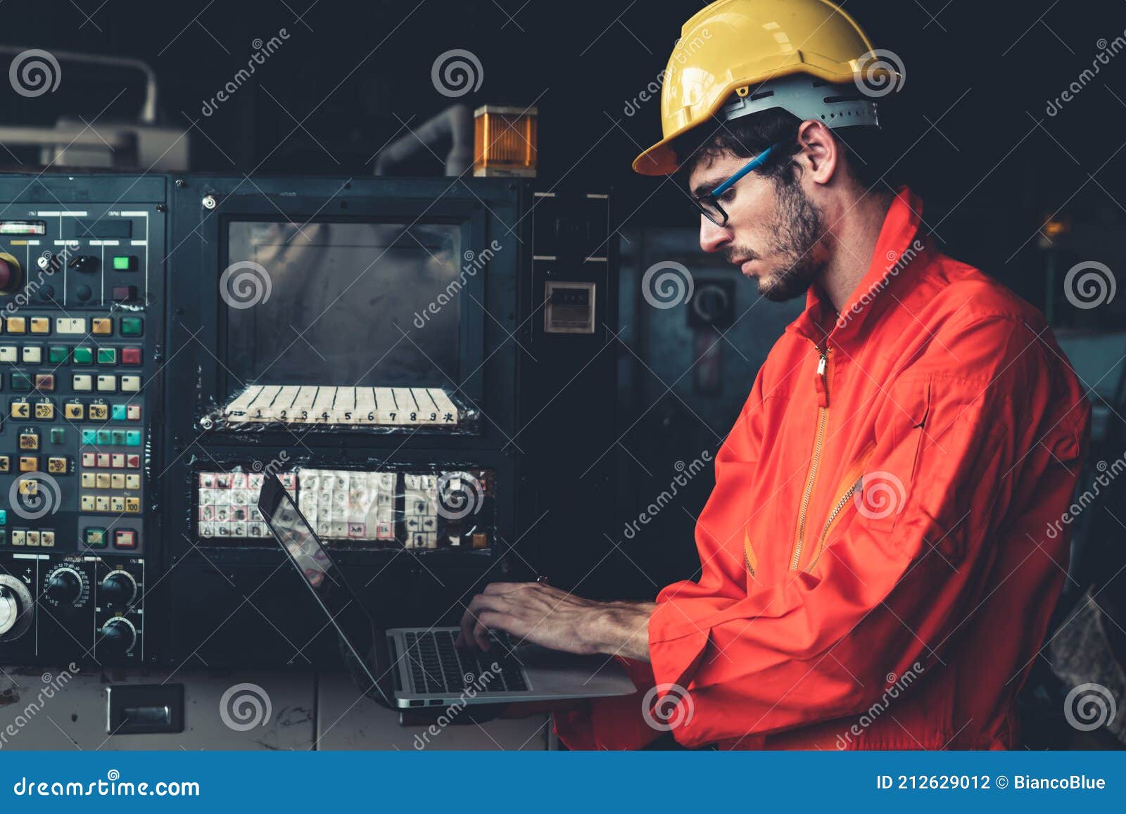 Skillful Factory Worker Working with Laptop Computer To Do Procedure ...