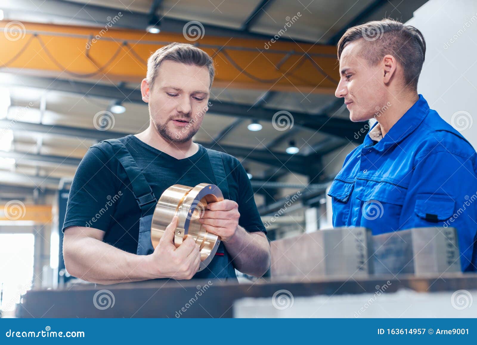 Master Discussing a Workpiece with His Apprentice or Trainee Stock ...